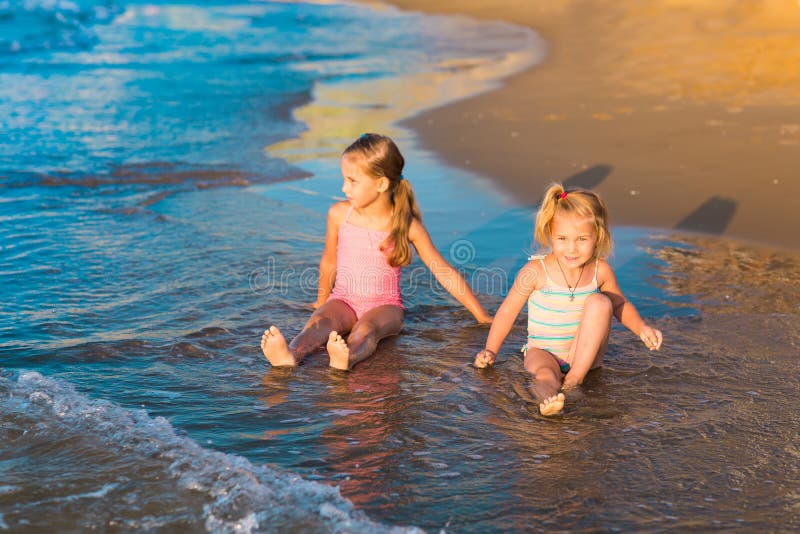 Two Adorable Kids Playing in the Sea on a Beach Stock Image - Image of ...
