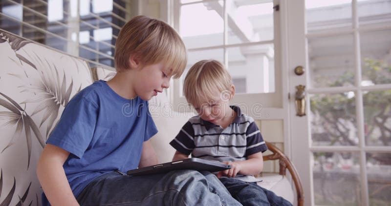Two Adorable Little Children Playing with a Tablet Computer Stock Video ...