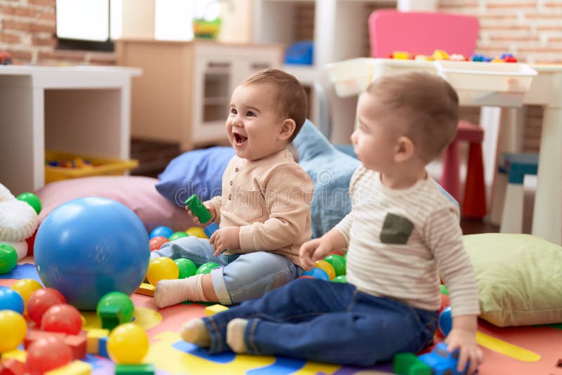 Two Adorable Toddlers Playing with Balls Sitting on Floor at ...