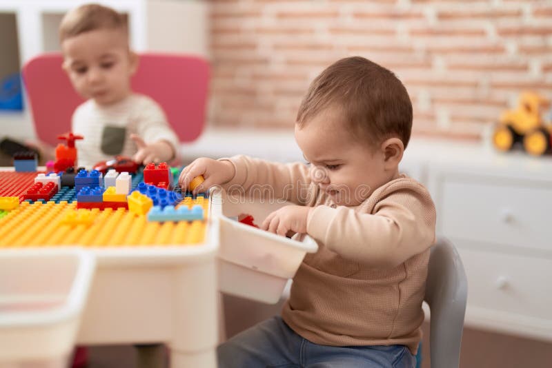 Two Adorable Toddlers Playing with Construction Blocks Sitting on Table ...