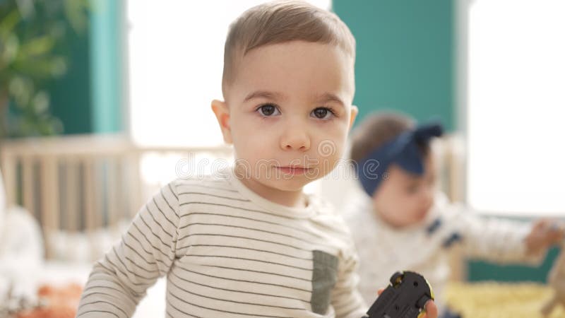 Two Adorable Toddlers Playing with Relaxed Expression at Bedroom Stock ...
