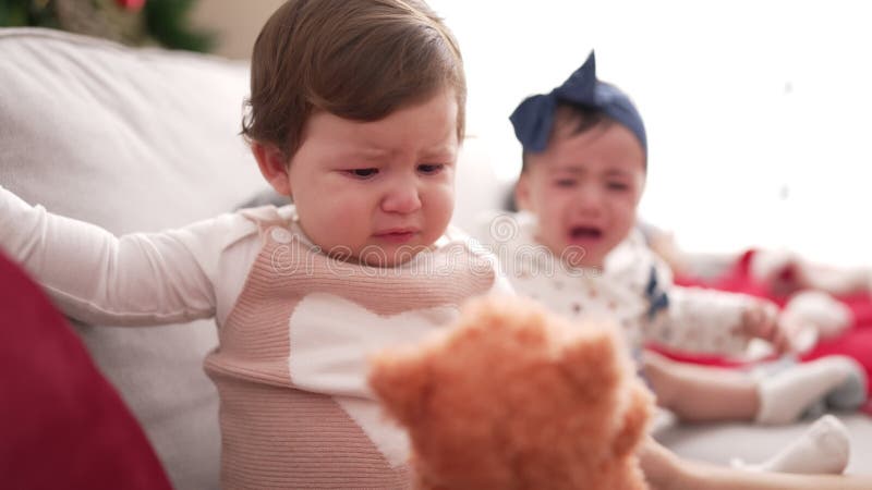 Two Adorable Toddlers Sitting on Sofa Crying at Home Stock Footage ...