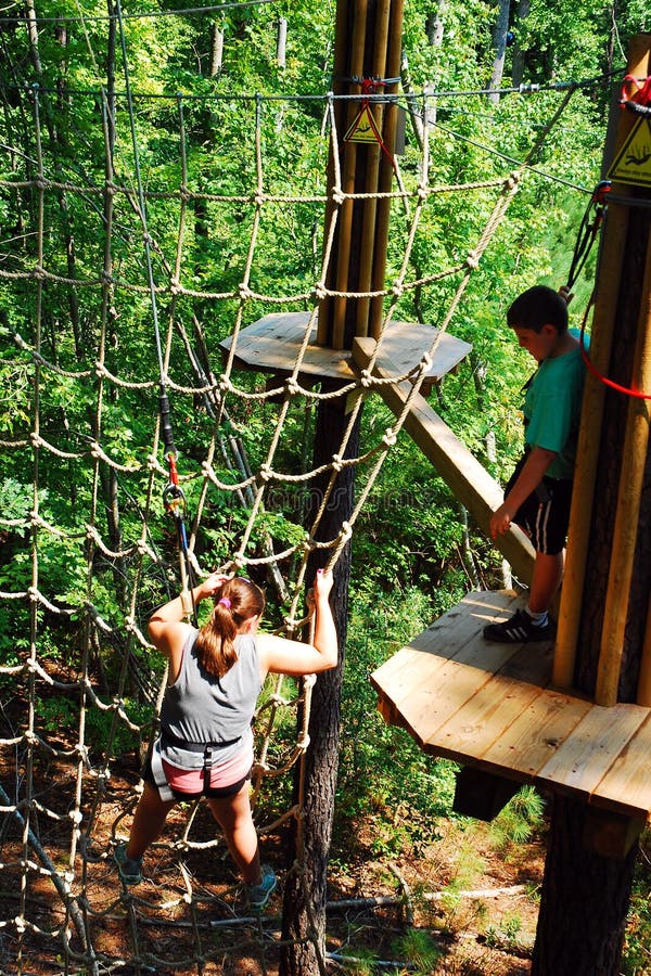 Two Adventurers Walk Across a Rope Web Stock Photo - Image of american ...