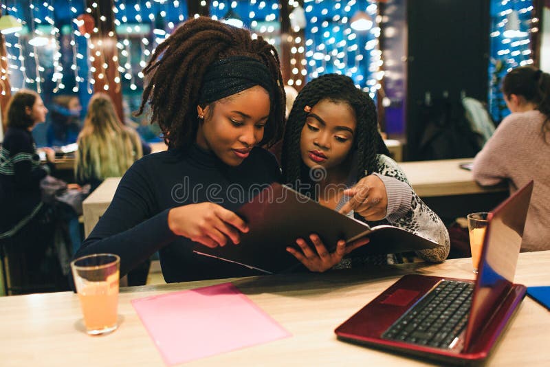 Two African Students Look at Opened Journal. they Sit and Study. they ...