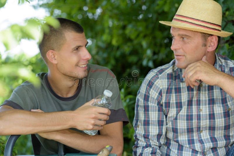 Two Agricultural Workers Taking Break Stock Image - Image of field ...