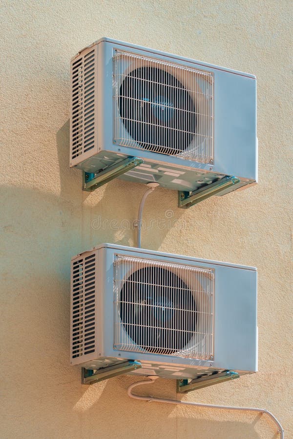 Two Air Conditioning External Units Mounted on Th Wall of Residential ...