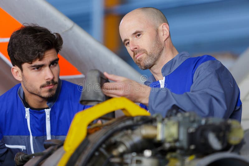 Two Aircraft Mechanics Checking Something Stock Photo - Image of work ...