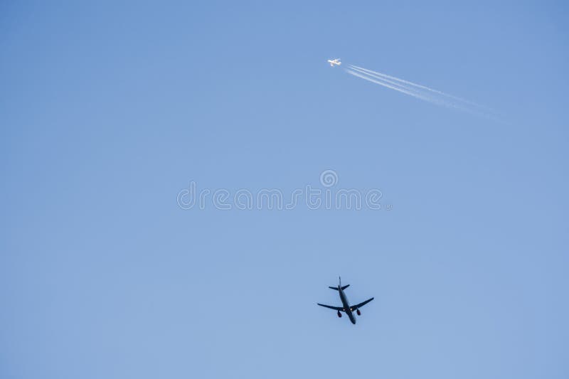 Two Airplanes Flying To Different Directions at the Blue Sky for ...