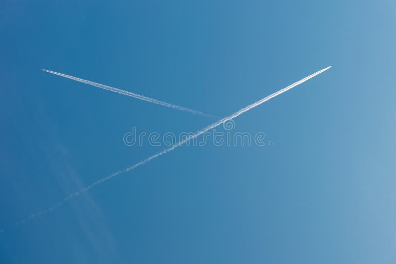 Two Airplanes Trails Crossing Against Blue Sky Stock Photo - Image of ...