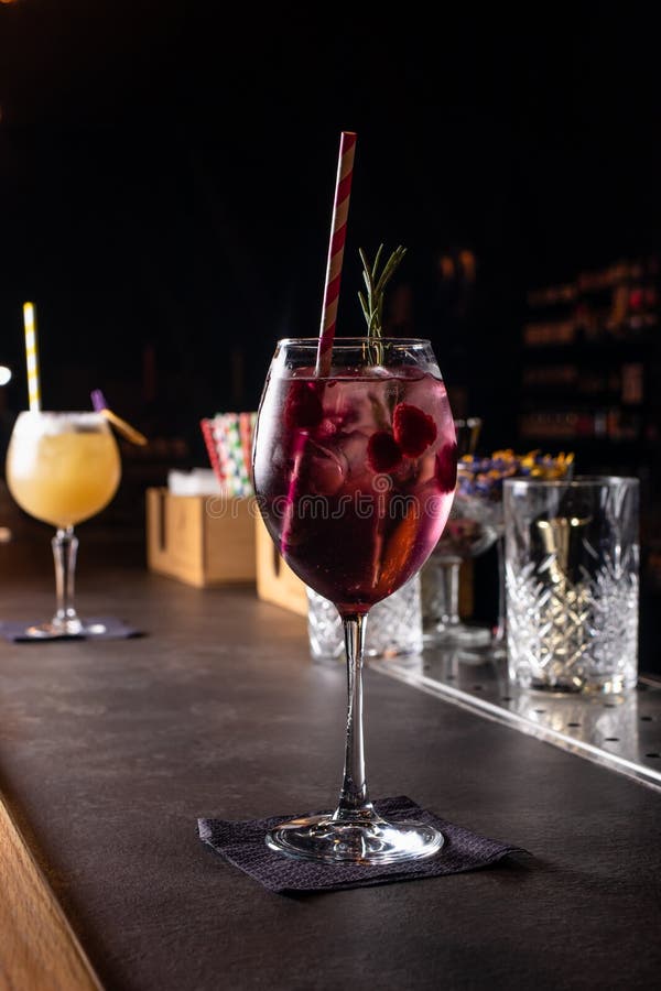 Two Alcoholic Cocktails Pink and Yellow on a Dark Bar. Stock Image ...