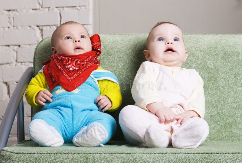 Two Babies Sitting on a Sofa Together Stock Photo - Image of lovely ...