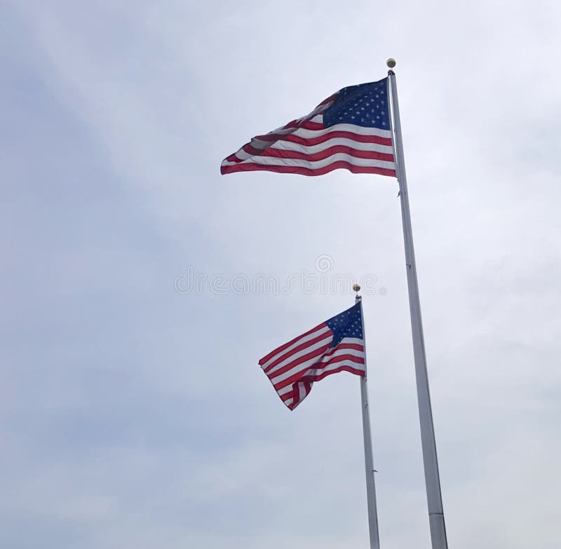 Two American Flags Flying in the Wind Stock Photo - Image of blue ...
