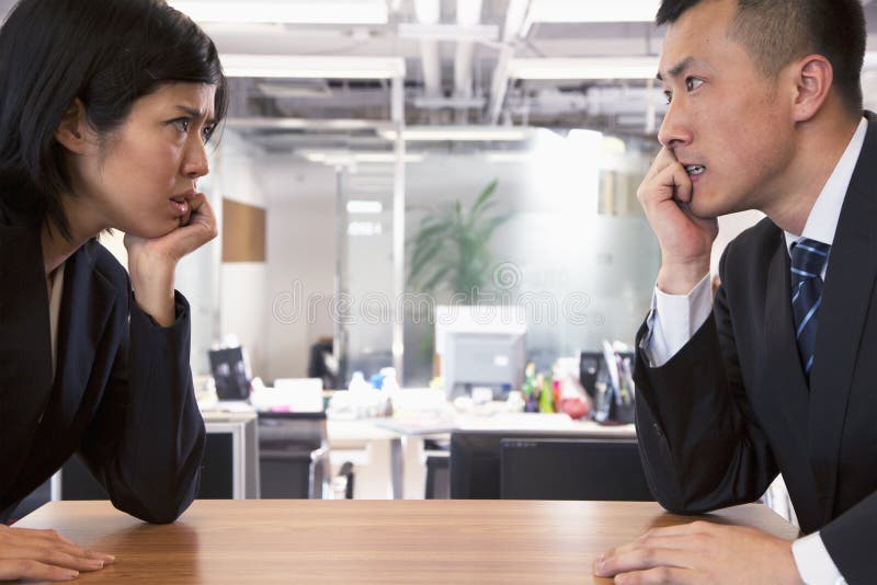Two Angry Business People Staring at Each Other Across a Table Stock ...