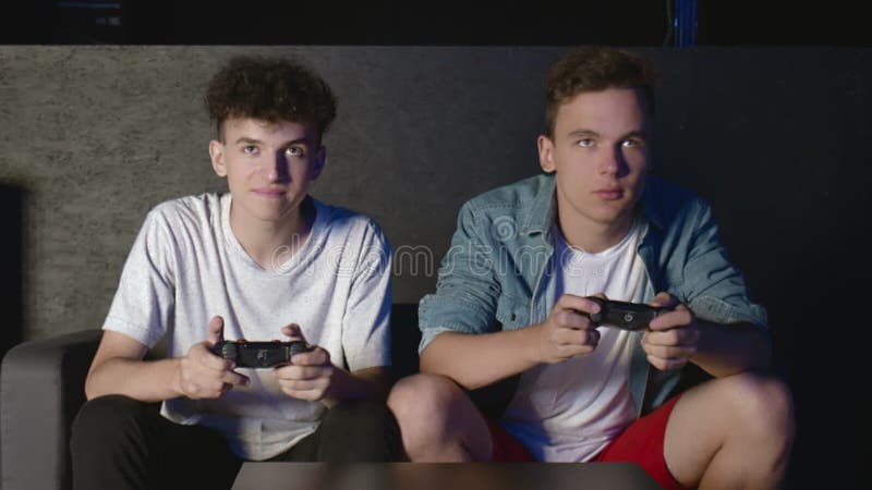 Two ANGRY Guys are Sitting on the Couch in Front of the TV and Losing ...