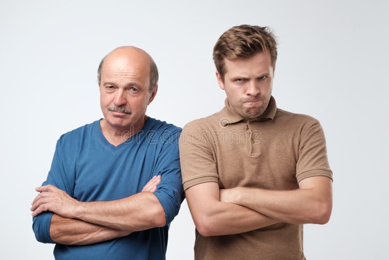 Grumpy Father and Daughter Standing in the Cold in Front of Bushes with Christmas Lights Stock ...