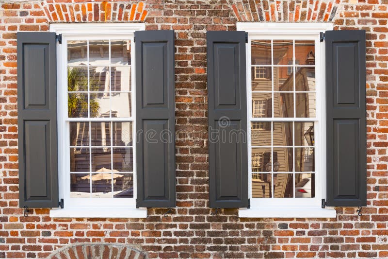 Two Antique Windows with Shutters in the Wall of a Brick House Stock ...