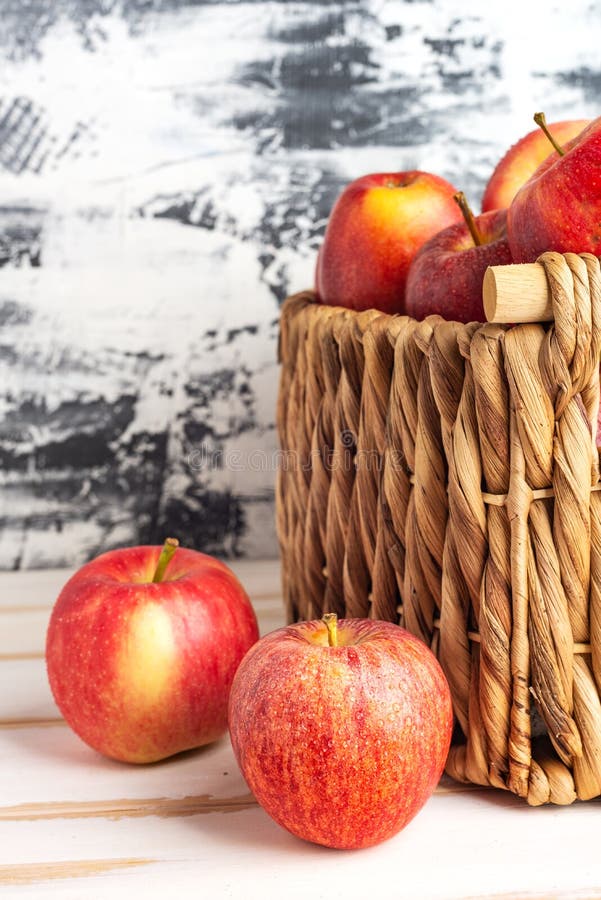 Two Apples on the Background of Wicker Basket Full of Ripe Apples Stock ...