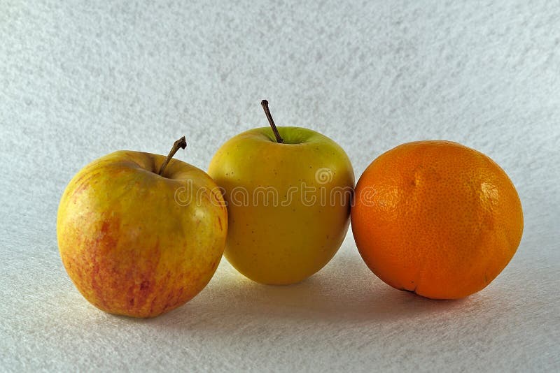 Two apples and one orange stock image. Image of edible - 88374821