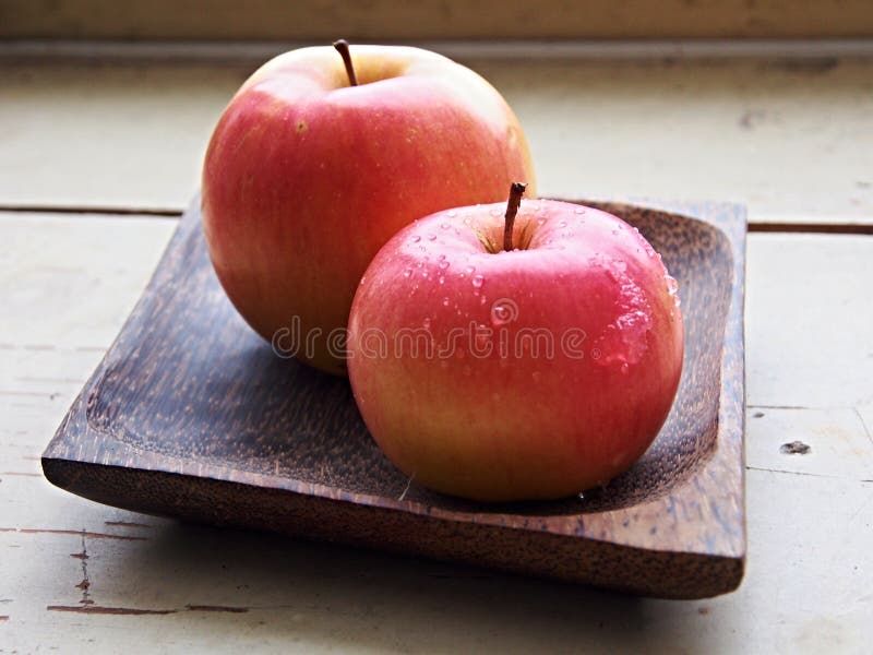 Two Apples on the Wooden Plate Stock Image - Image of fruit, wood ...