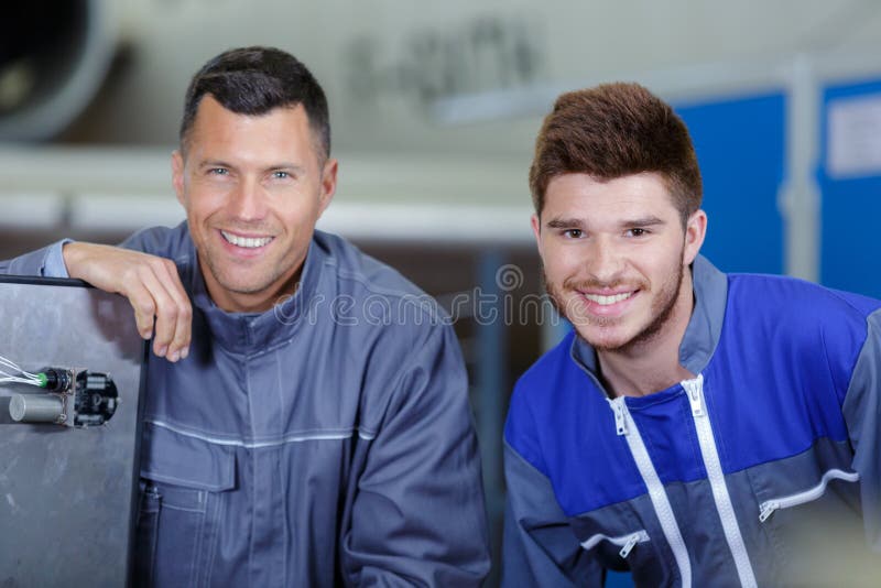 Two Apprentice Mechanics Looking To Camera Stock Photo - Image of ...