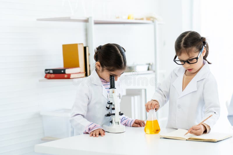Two Arab Schoolgirls Having Fun Learning Science with the Practice of ...