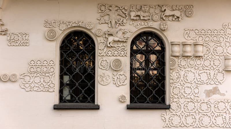 Two Lovely Arched Windows with Wrought Iron Bars on a Building Stock ...