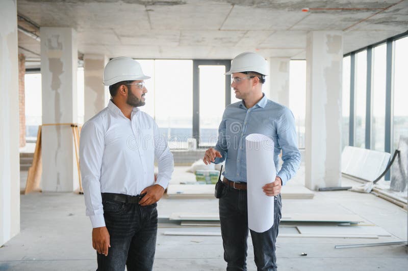 Two Architect Engineers Talking in a Constructed Office Building Stock ...
