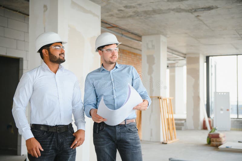 Two Architect Engineers Talking in a Constructed Office Building Stock ...
