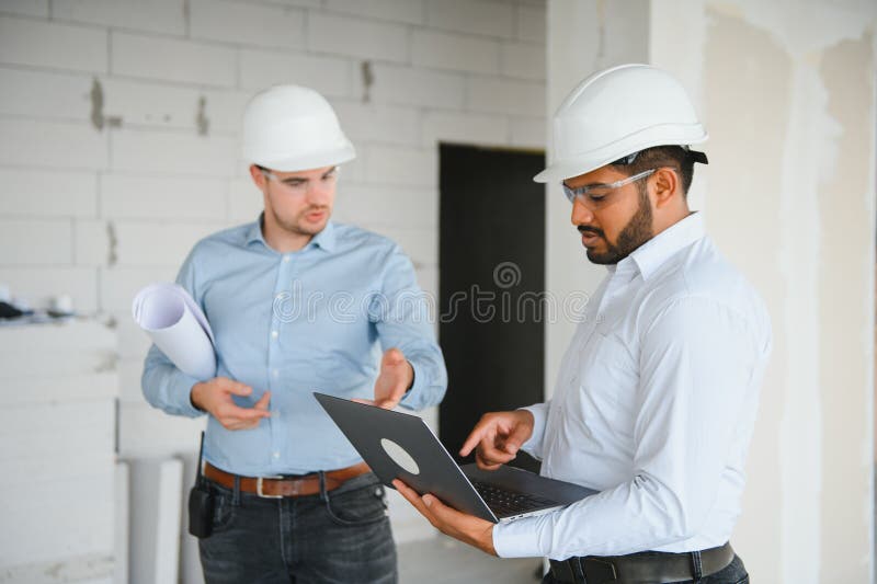 Two Architect Engineers Talking in a Constructed Office Building Stock ...