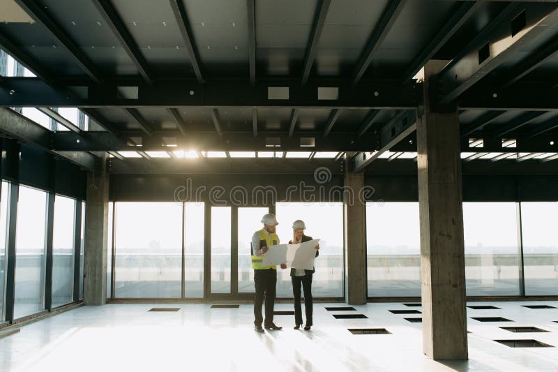 Two Architect Engineers are Walking in a Constructed Office Building ...