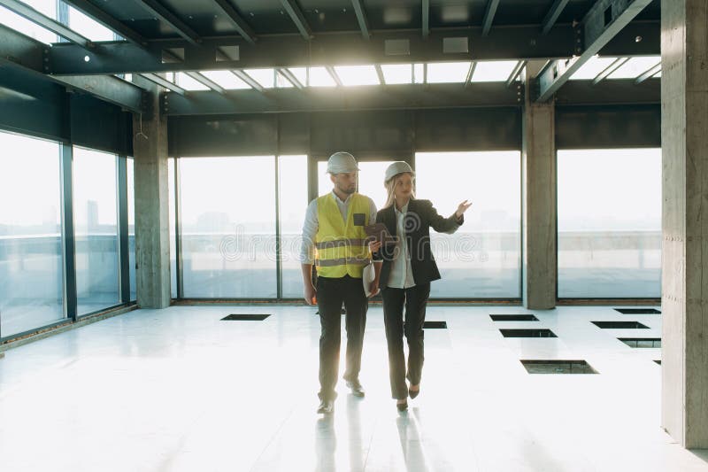 Two Architect Engineers are Walking in a Constructed Office Building ...