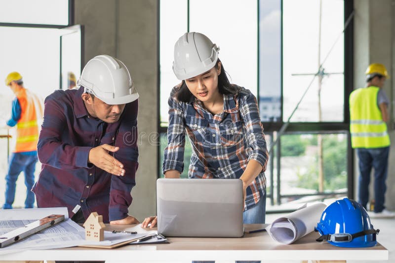 Two Architect Look at Blueprint and Planning To Renovation Room Stock ...