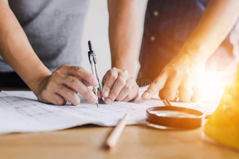 Two Architect Plan and Design by Using Circus on Blue Print on Table in ...