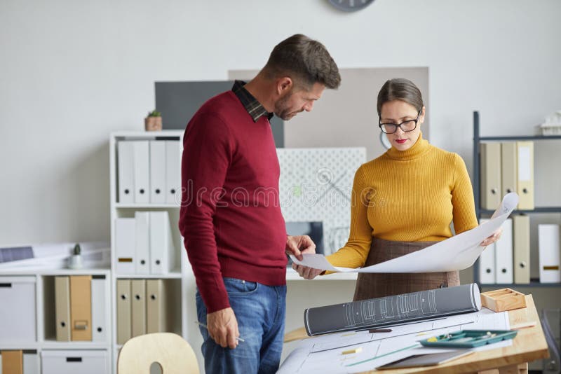 Two Architects Discussing Plans at Workplace Stock Photo - Image of ... Two Architects Discussing Plans at Workplace Stock Photo - Image of ...