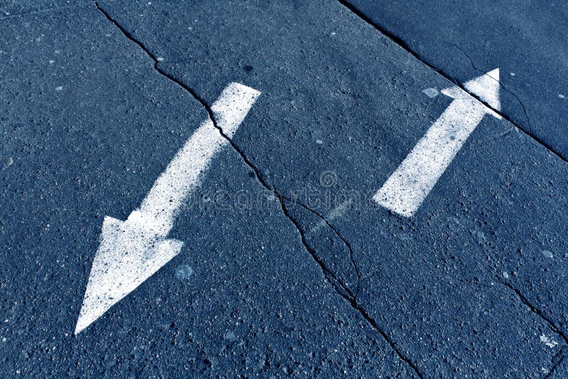 Two Arrows on Blue Toned Cracked Asphalt Surface. Stock Image - Image ...