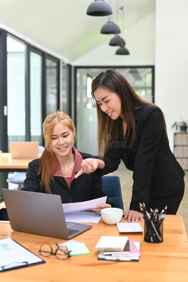 Two Asian Business Colleagues are Discussing Business Plan, Working on ...
