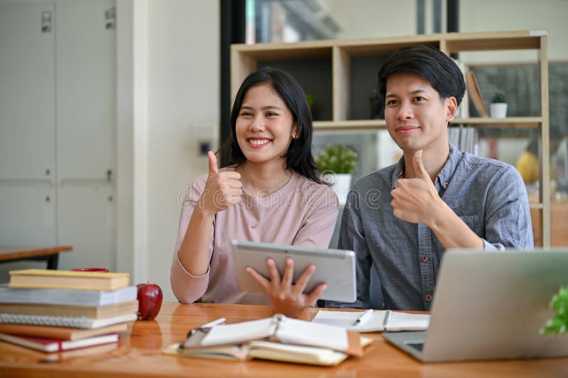 Two Asian College Students are Showing Their Thumbs Up while Studying ...