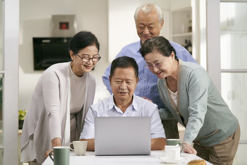 Two Asian Couples Using Laptop Together Indoors Stock Image - Image of ...