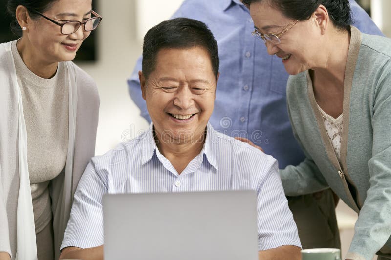 Two Asian Couples Using Laptop Together Indoors Stock Image - Image of ...