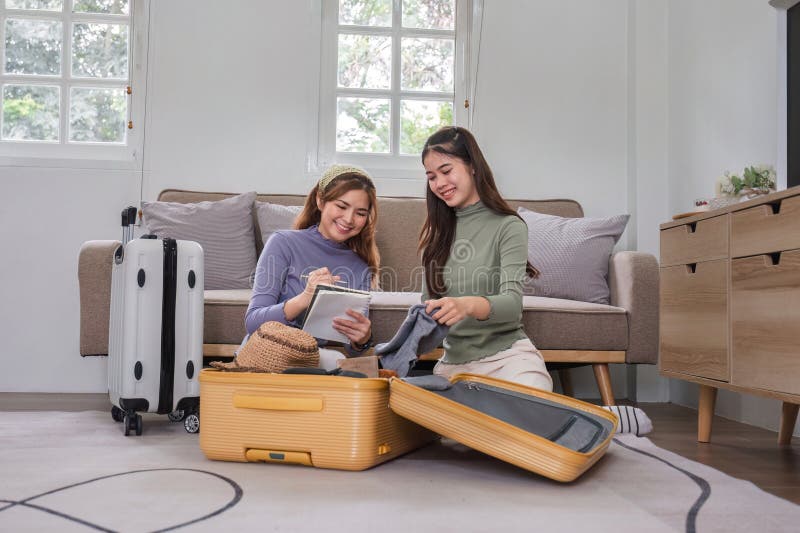 Two Asian Female Friends Plan a Vacation, Pack Their Suitcases before ...