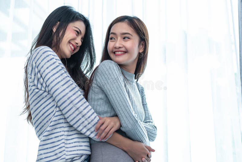Two Asian Lesbian Women Hug And Embracing Together In Bedroom Couple