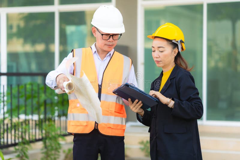 Two Asian Male and Female Engineers Inspecting Work Two Female Architects are Working Stock ...