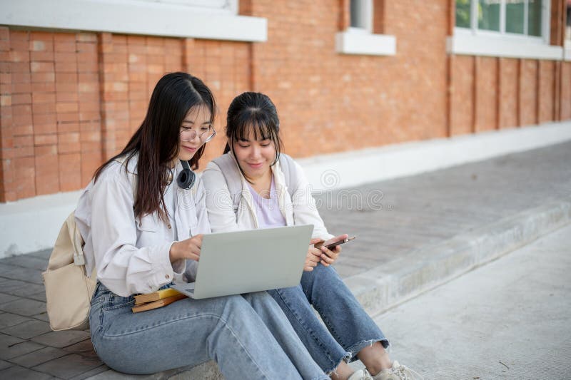 Two Asian School Best Friends are Talking and Working on a Project ...