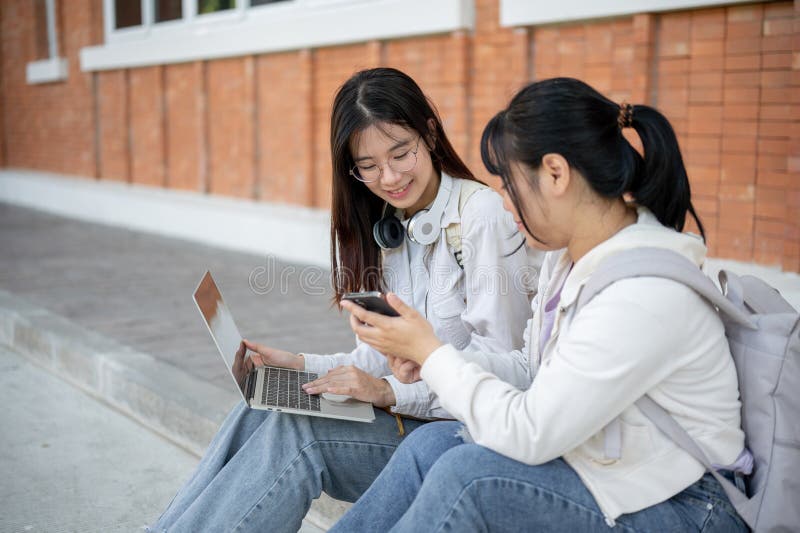 Two Asian School Best Friends are Talking and Working on a Project ...