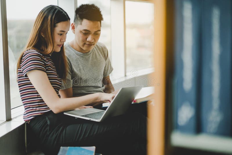 Two Asian Students Researching for Project in Library Stock Photo ...