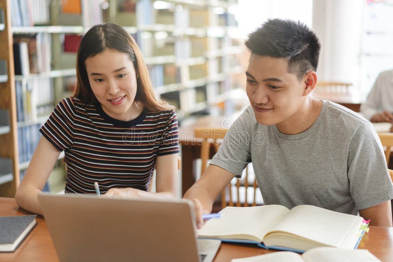Two Asian Students Researching for Project in Library Stock Photo ...