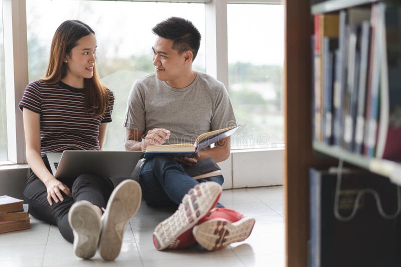 Two Asian Students Researching for Project in Library Stock Photo ...