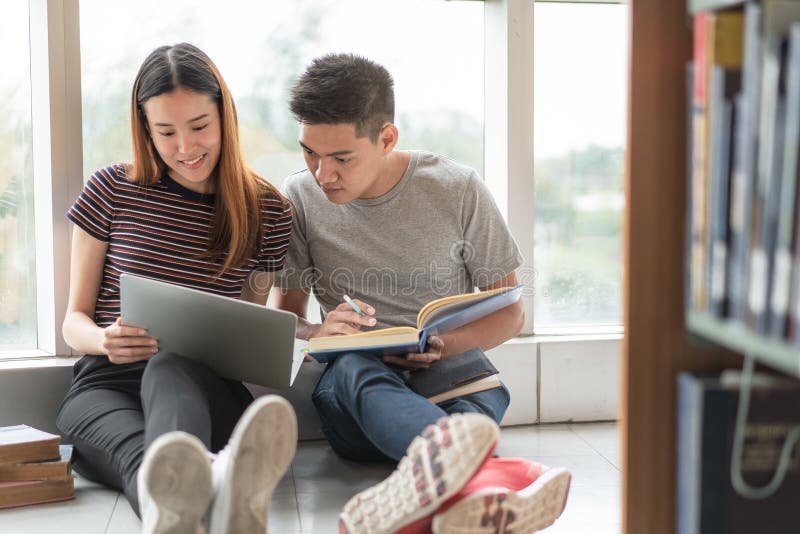 Two Asian Students Researching for Project in Library Stock Photo ...