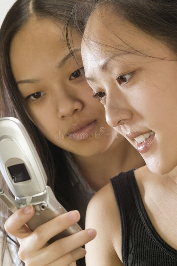 Two Asian Women Using Cell Phone Stock Image - Image of access ...