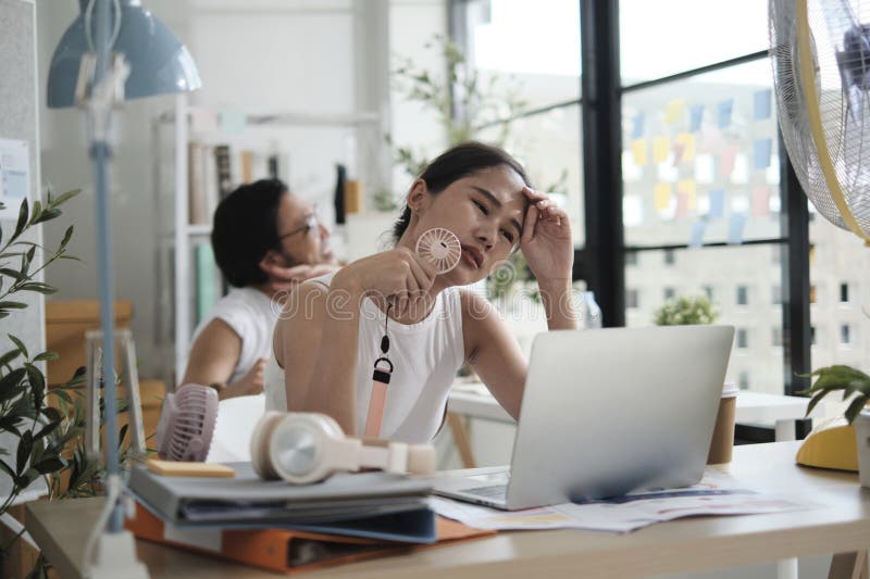 Two Asian Workers are Unhappy Working with Hot Temperatures at Office ...